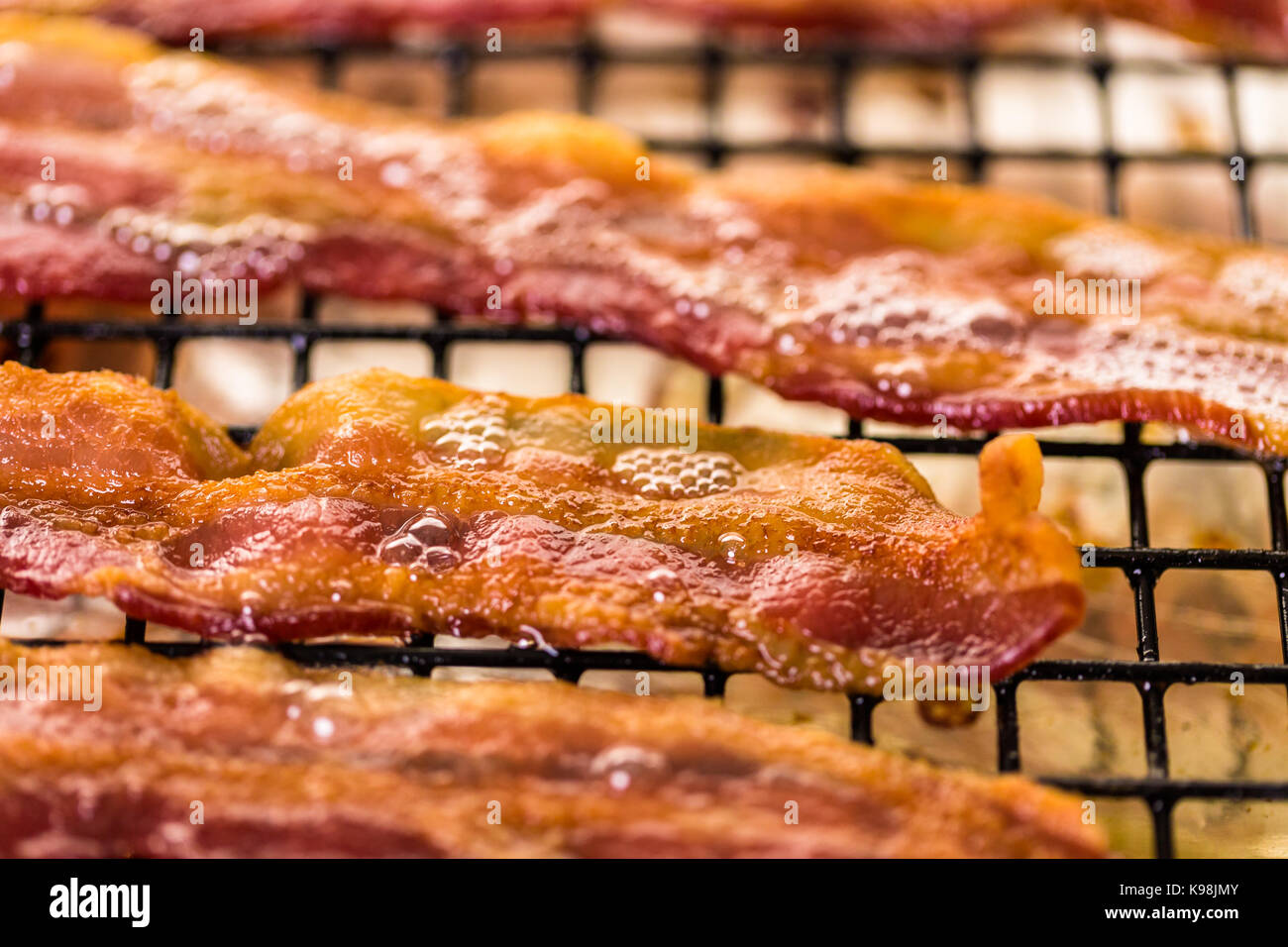 Cooked bacon strips on a baking sheet Stock Photo - Alamy