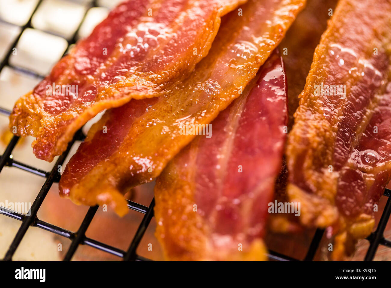 Cooked bacon strips on a baking sheet Stock Photo - Alamy