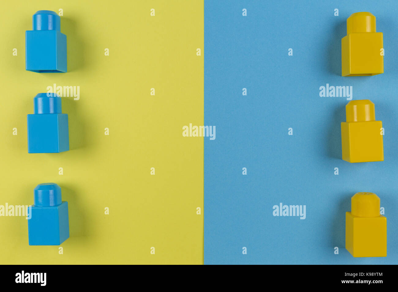 Yellow and blue plastic construction blocks on yellow and blue ...