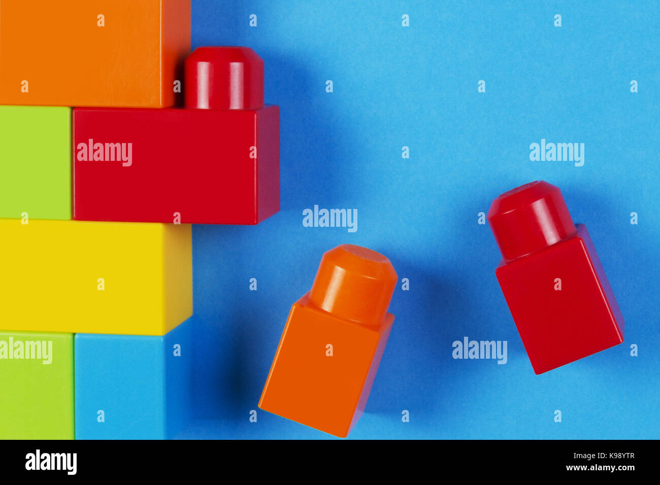 Colorful plastic construction blocks on blue background Stock Photo - Alamy