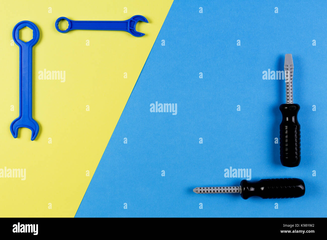 Toys background. Kids construction toys tools on blue and yellow ...