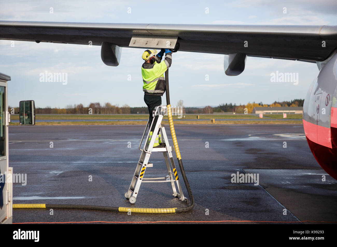 Male Worker Refueling Airplane While Standing On Step Ladder Stock ...