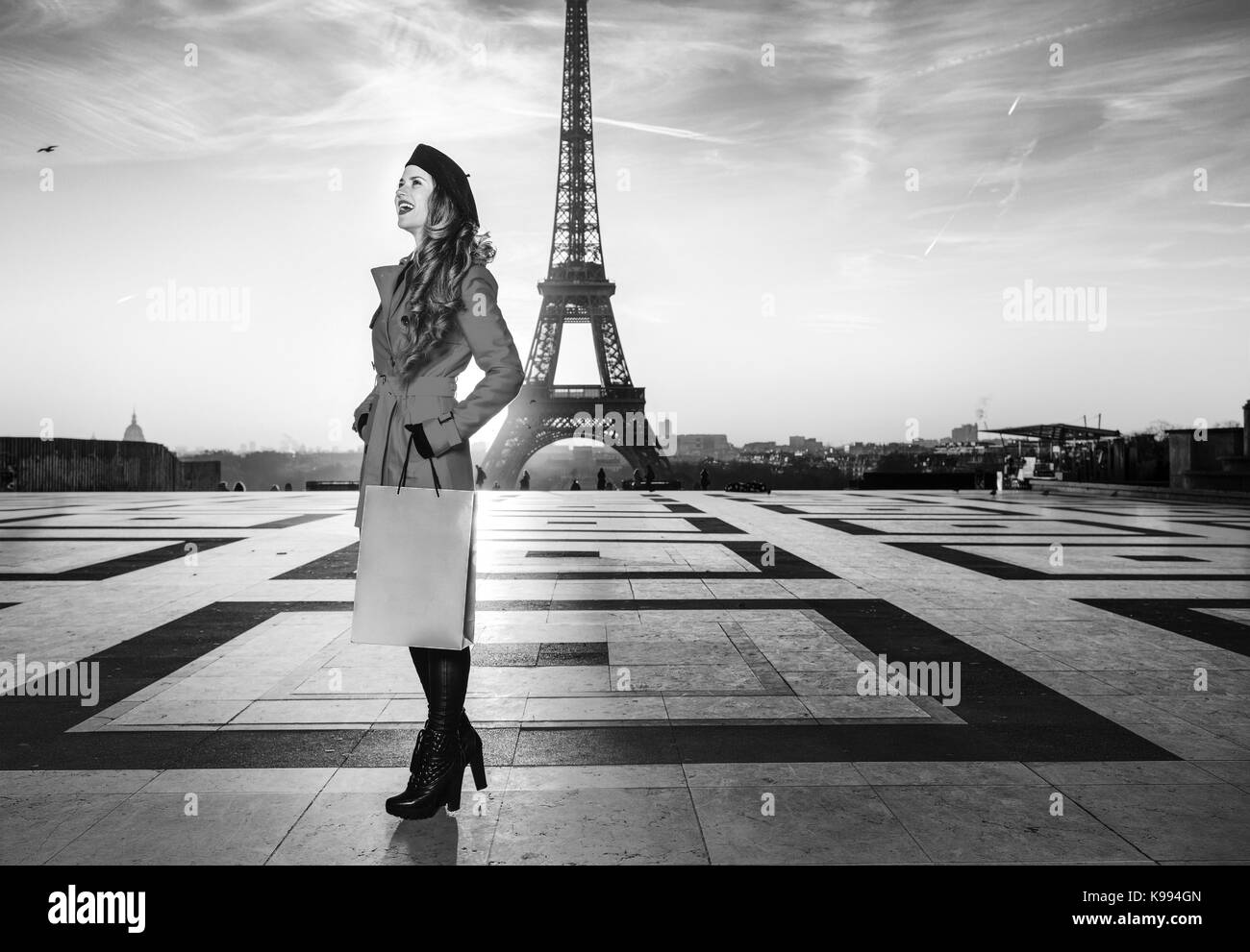 Bright in Paris. Full length portrait of smiling stylish woman in red ...