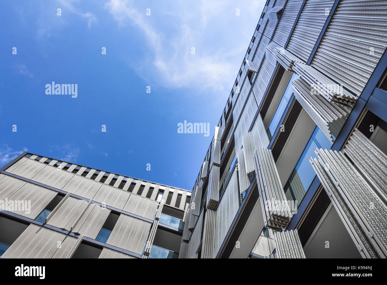 Modern building in a sunny day. Bottom view Stock Photo - Alamy