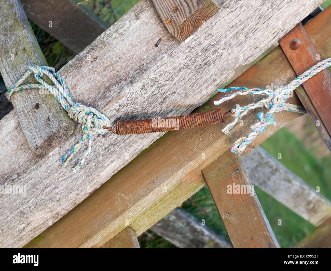 rusted spring metal element on countryside gate detail sharp; England ...
