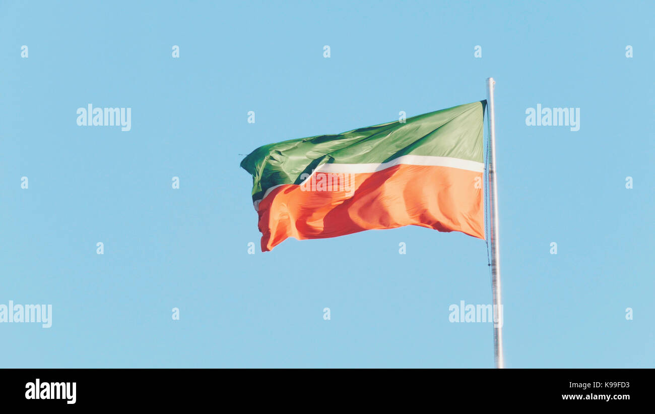 Flag of Tatarstan flutters in the wind in front of blue sky, Kazan ...