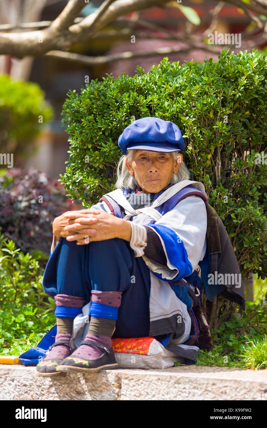 Lijiang, China - September 30, 2007: A mature Naxi woman dressed in ...