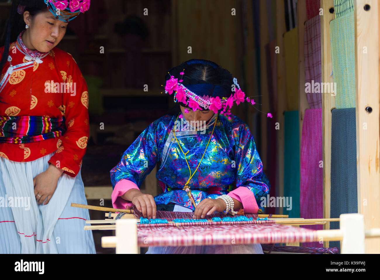 Weaving demonstration with woman in traditional dress hi-res stock ...