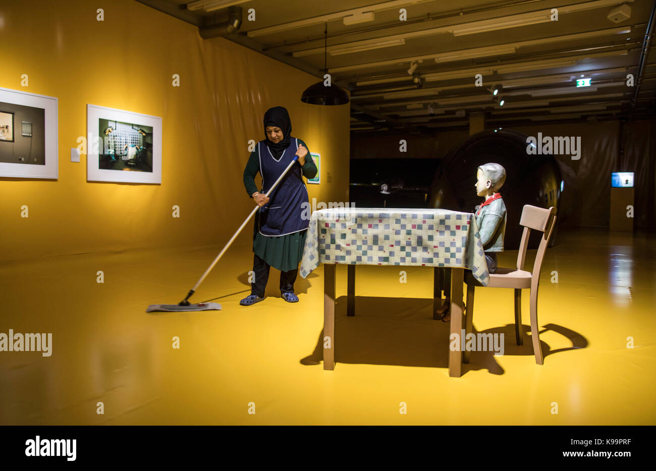 A worker cleans the floor in the exhibition rooms covered in yellow ...