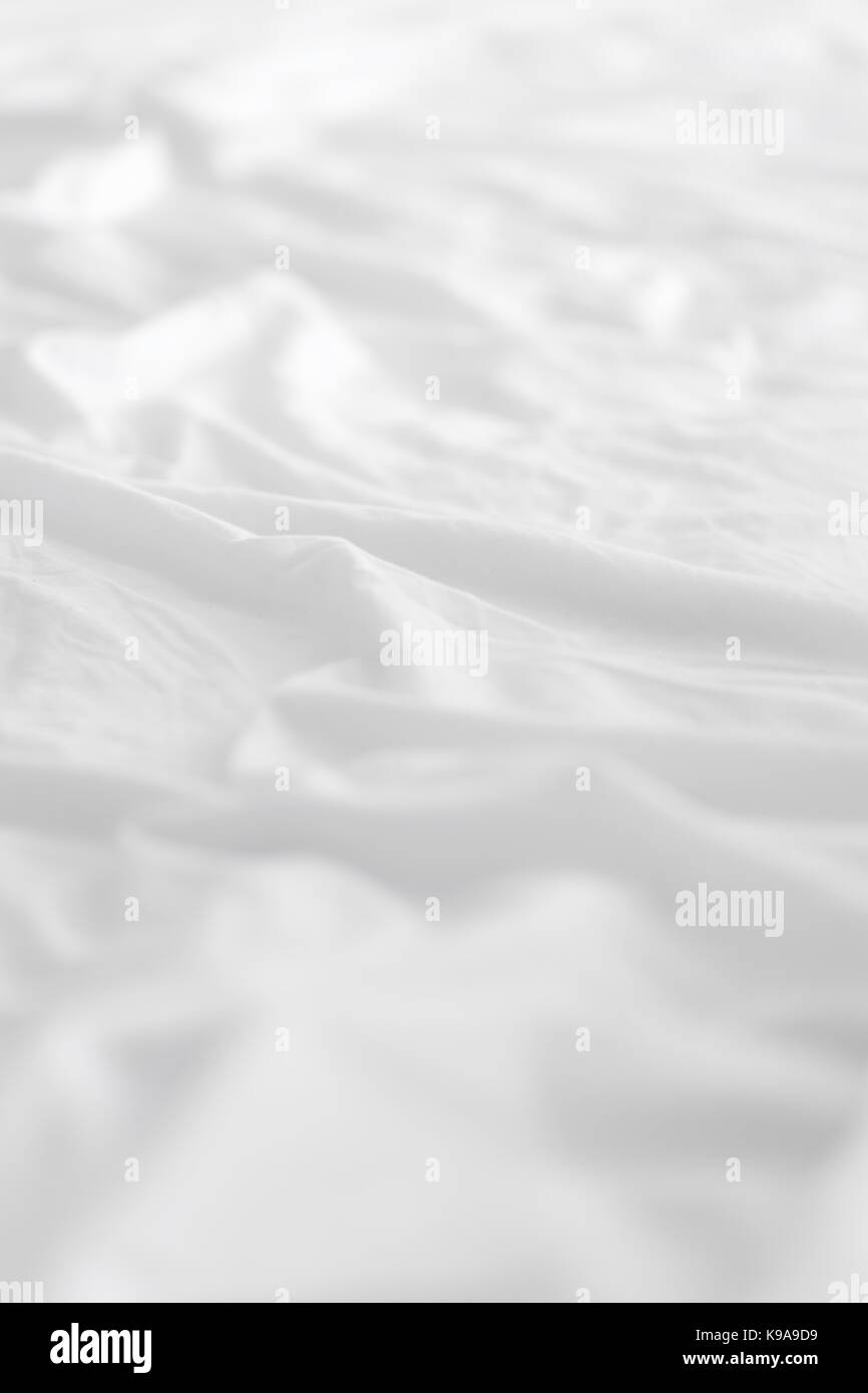 Soft white wrinkle bed sheets for background Stock Photo - Alamy