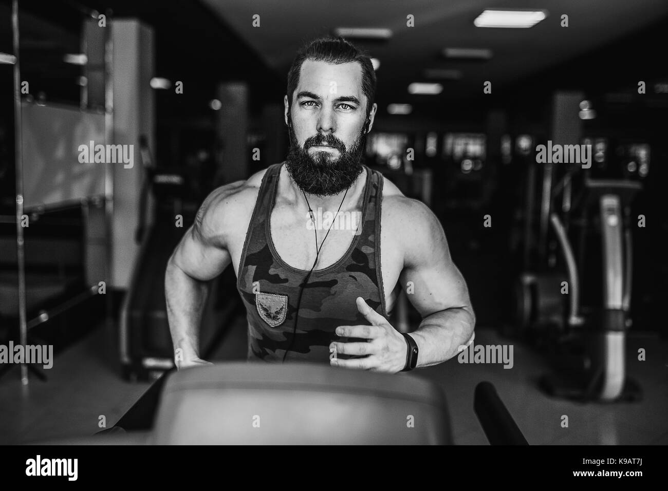Muscle man running on treadmill Stock Photo - Alamy
