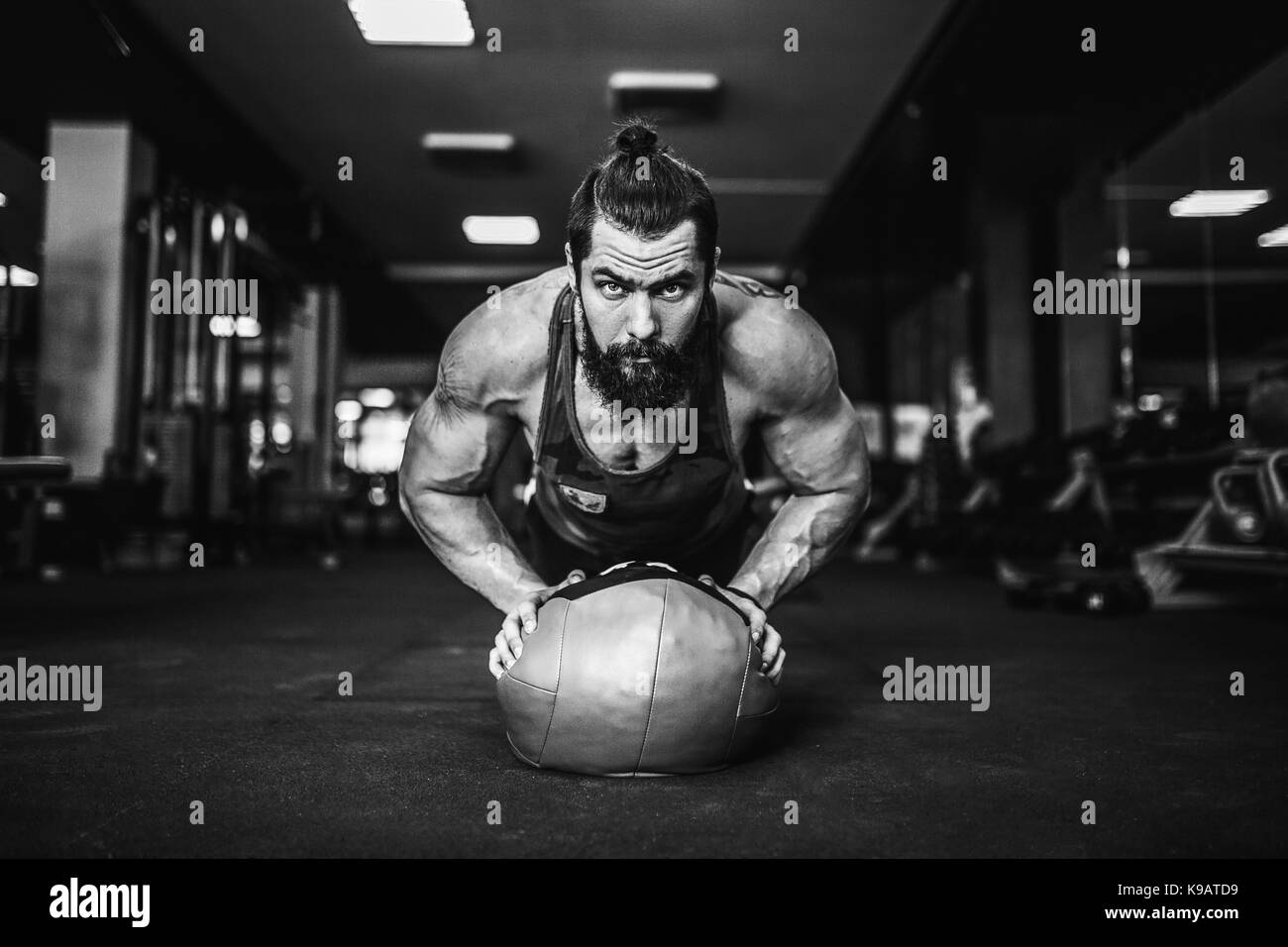 Muscled young man wearing sport wear and doing plank position while ...