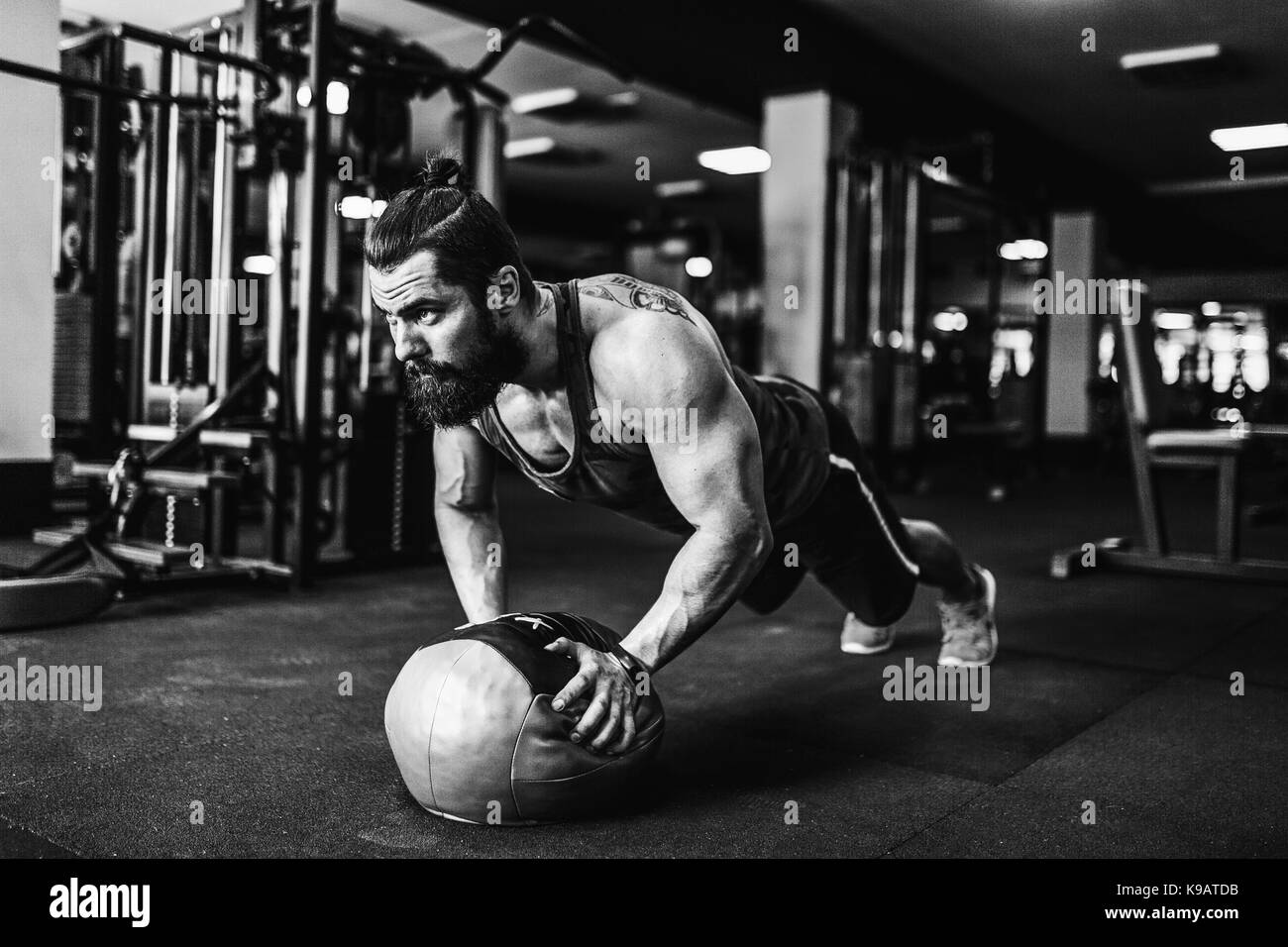 Muscled young man wearing sport wear and doing plank position while ...
