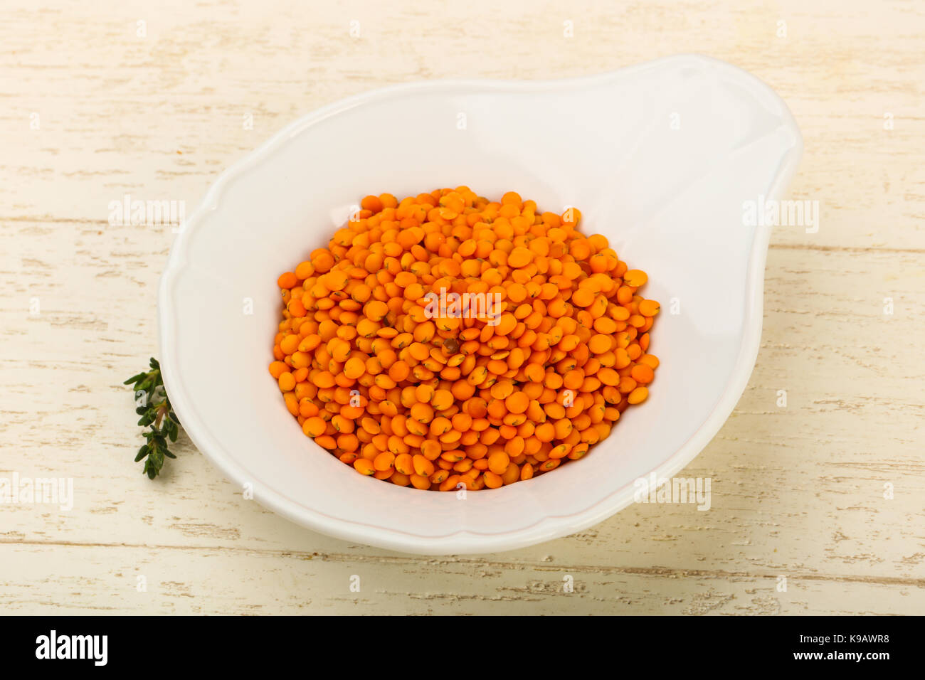 Orange lentil in the bowl over wooden background Stock Photo - Alamy