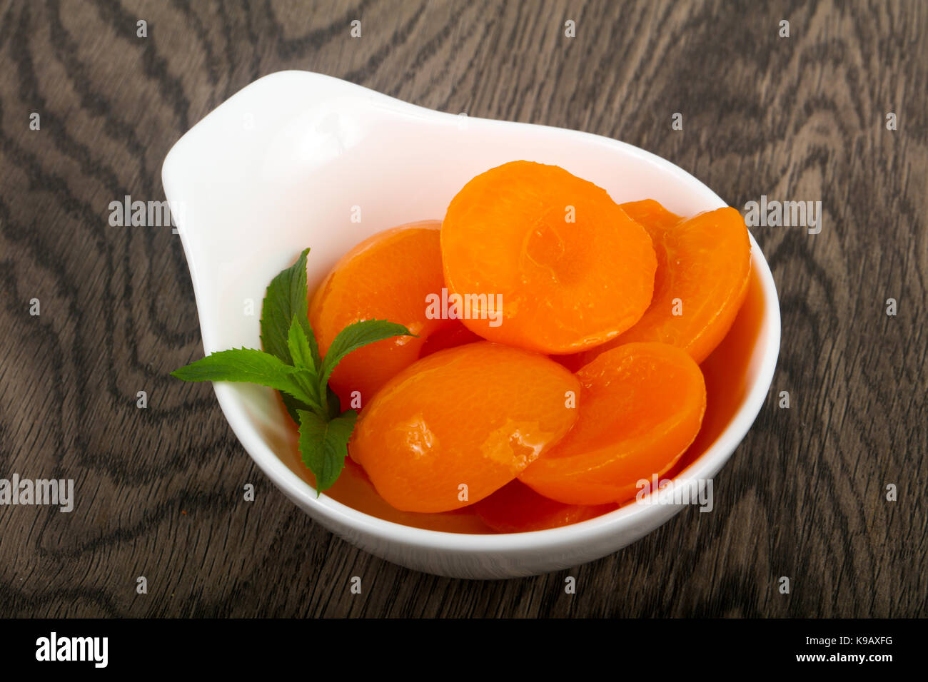 Canned apricots with mint leaves Stock Photo - Alamy