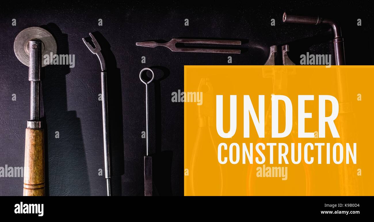 Digital composite of Under construction message on images of tools laid ...