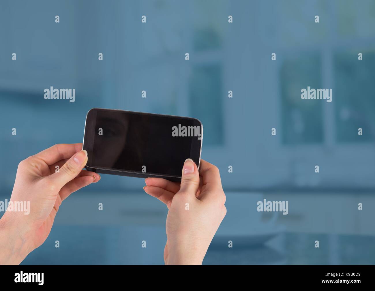 Digital composite of Hand holding phone at home Stock Photo - Alamy