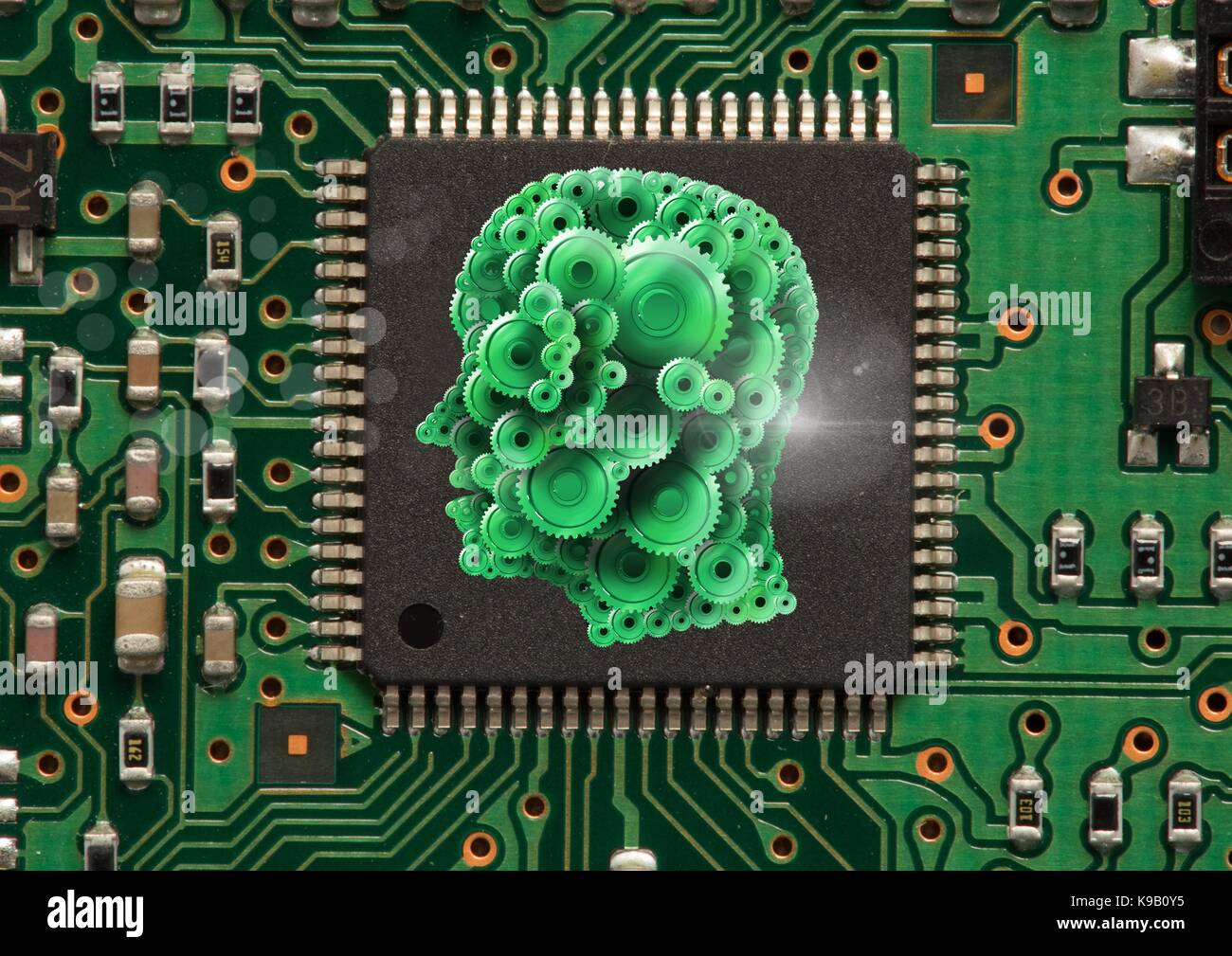 Digital composite of Cog head in center of microchip Stock Photo - Alamy
