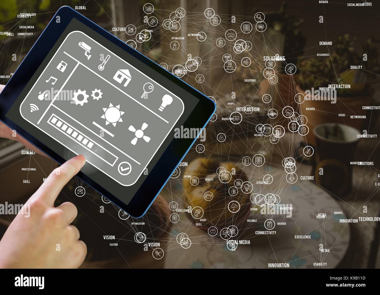 Digital composite of Hand holding tablet with smart home interface and ...