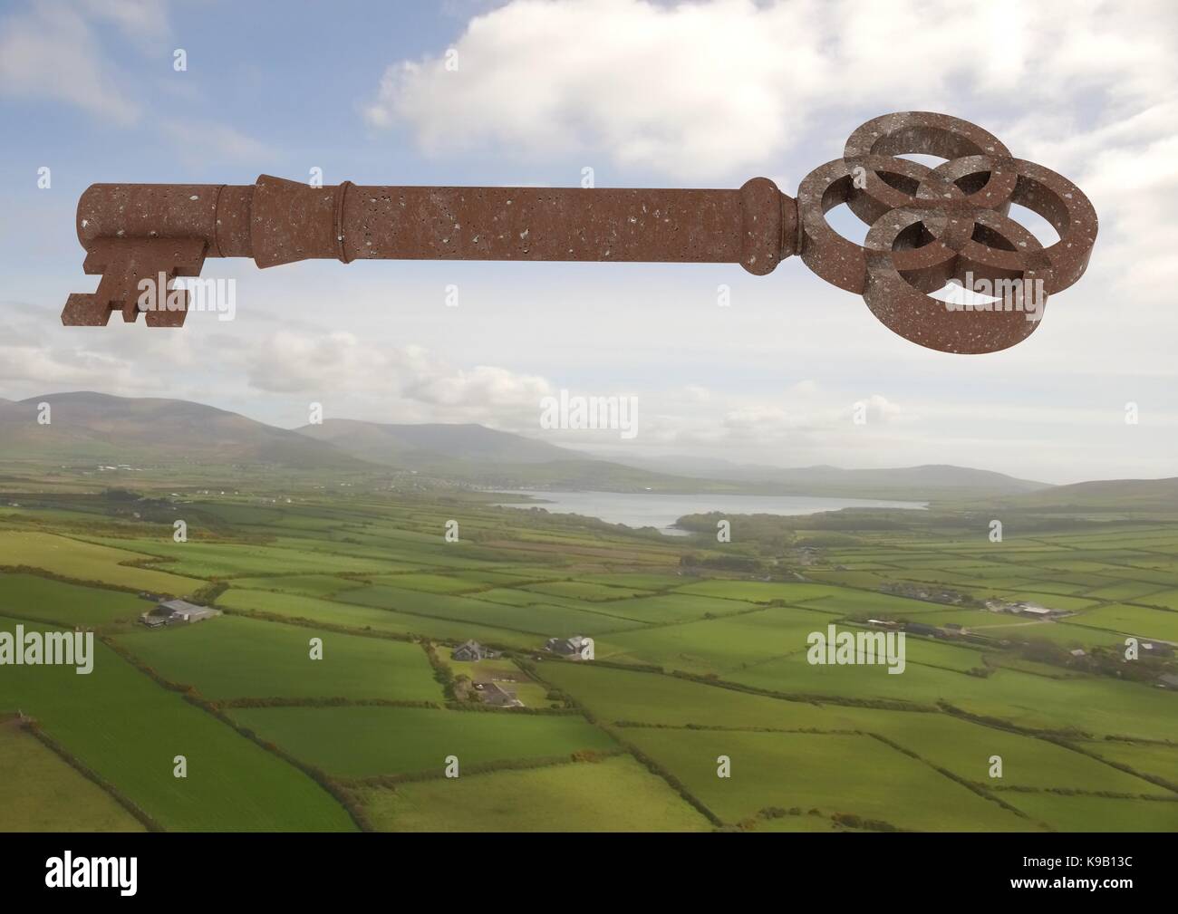 Digital composite of 3D Rustic Key floating over green landscape Stock ...