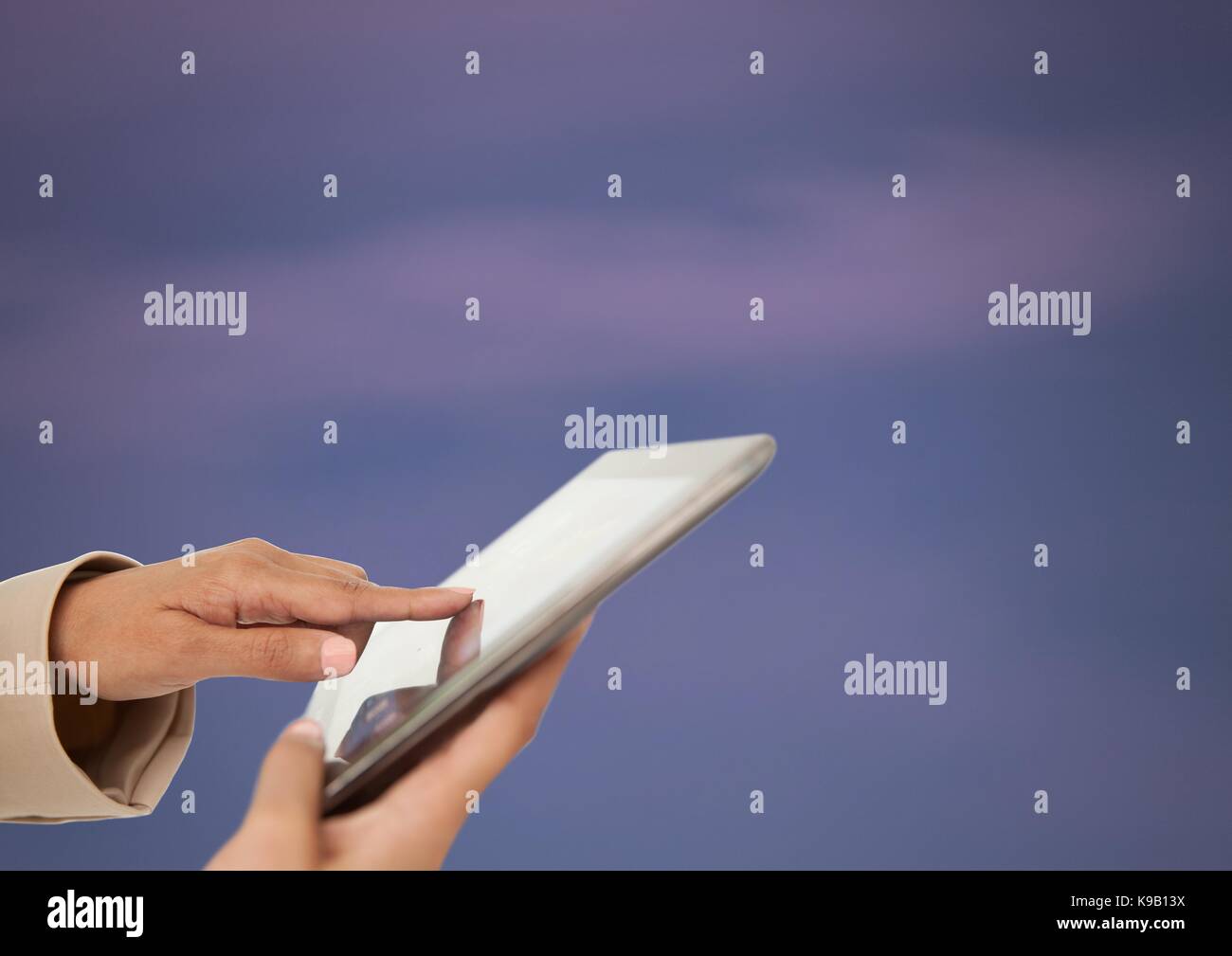 Digital composite of Hand holding tablet at home Stock Photo - Alamy