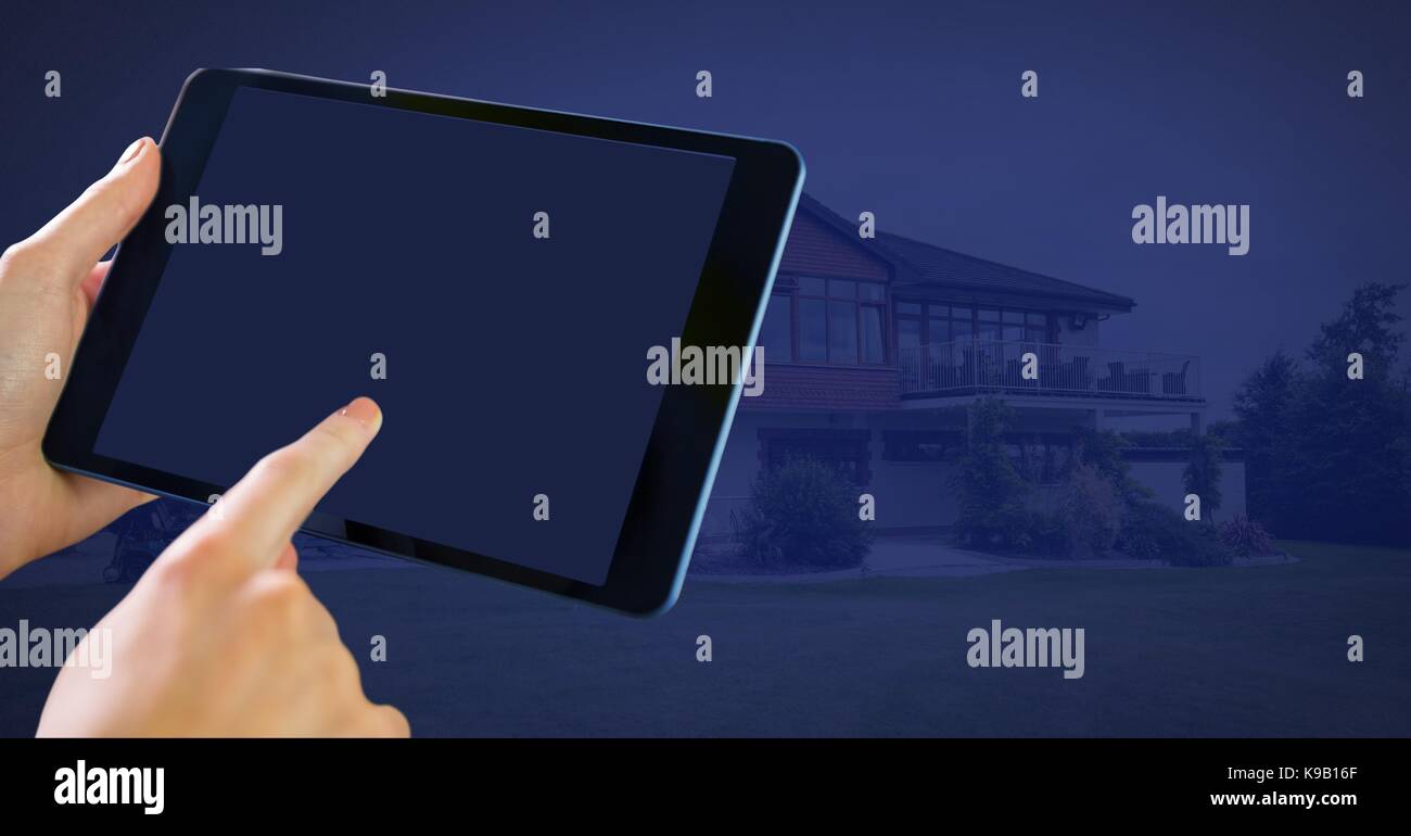 Digital composite of Hand holding tablet at home Stock Photo - Alamy