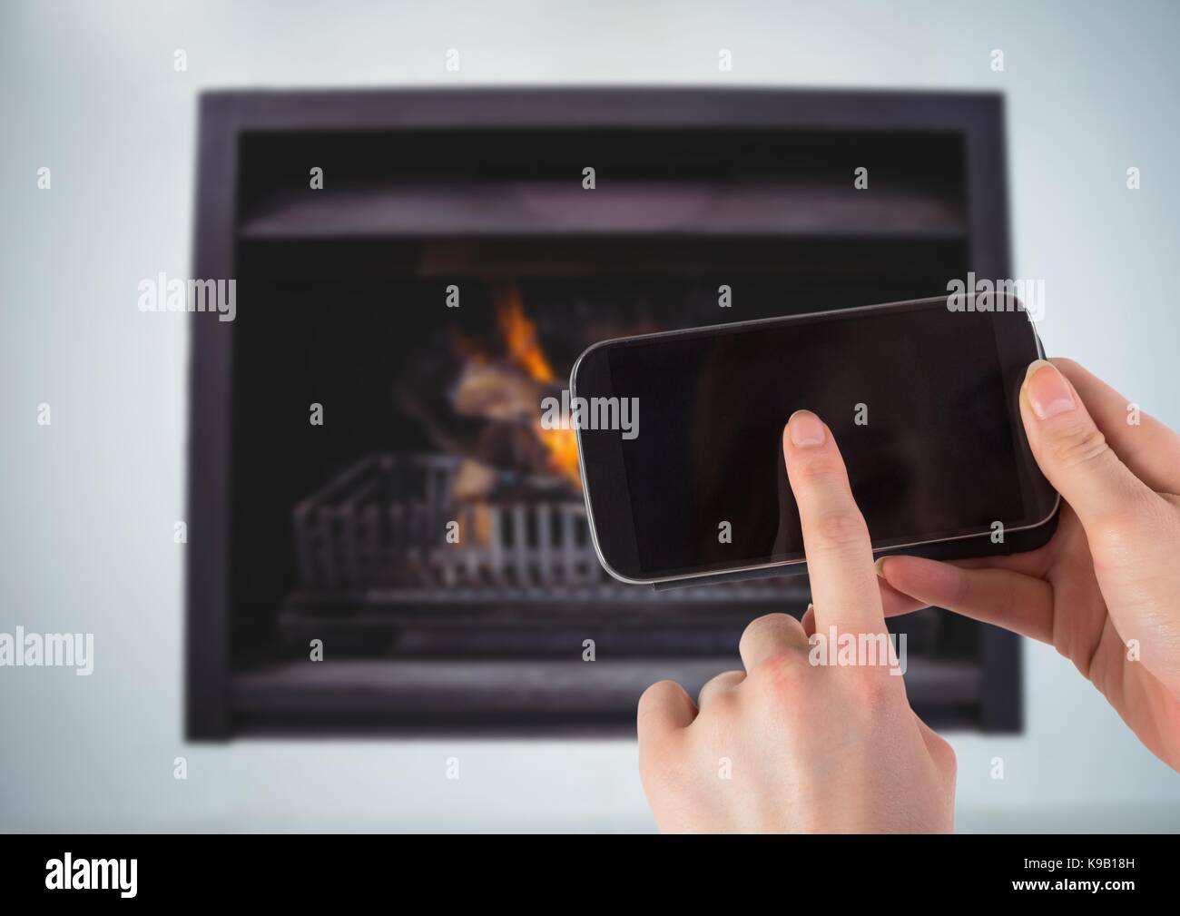 Digital composite of Hand holding phone at home Stock Photo - Alamy