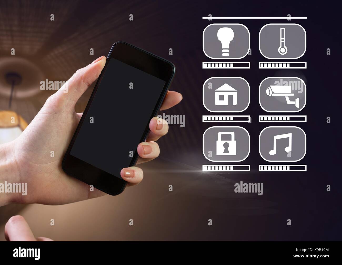 Digital composite of Hand holding phone with smart home interface at ...