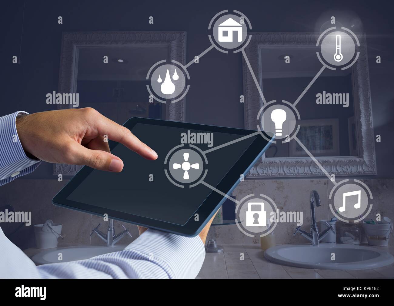 Digital composite of Hand holding tablet with smart home interface at ...