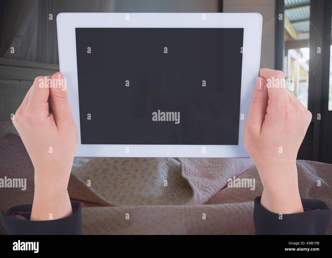 Digital composite of Hand holding tablet at home Stock Photo - Alamy