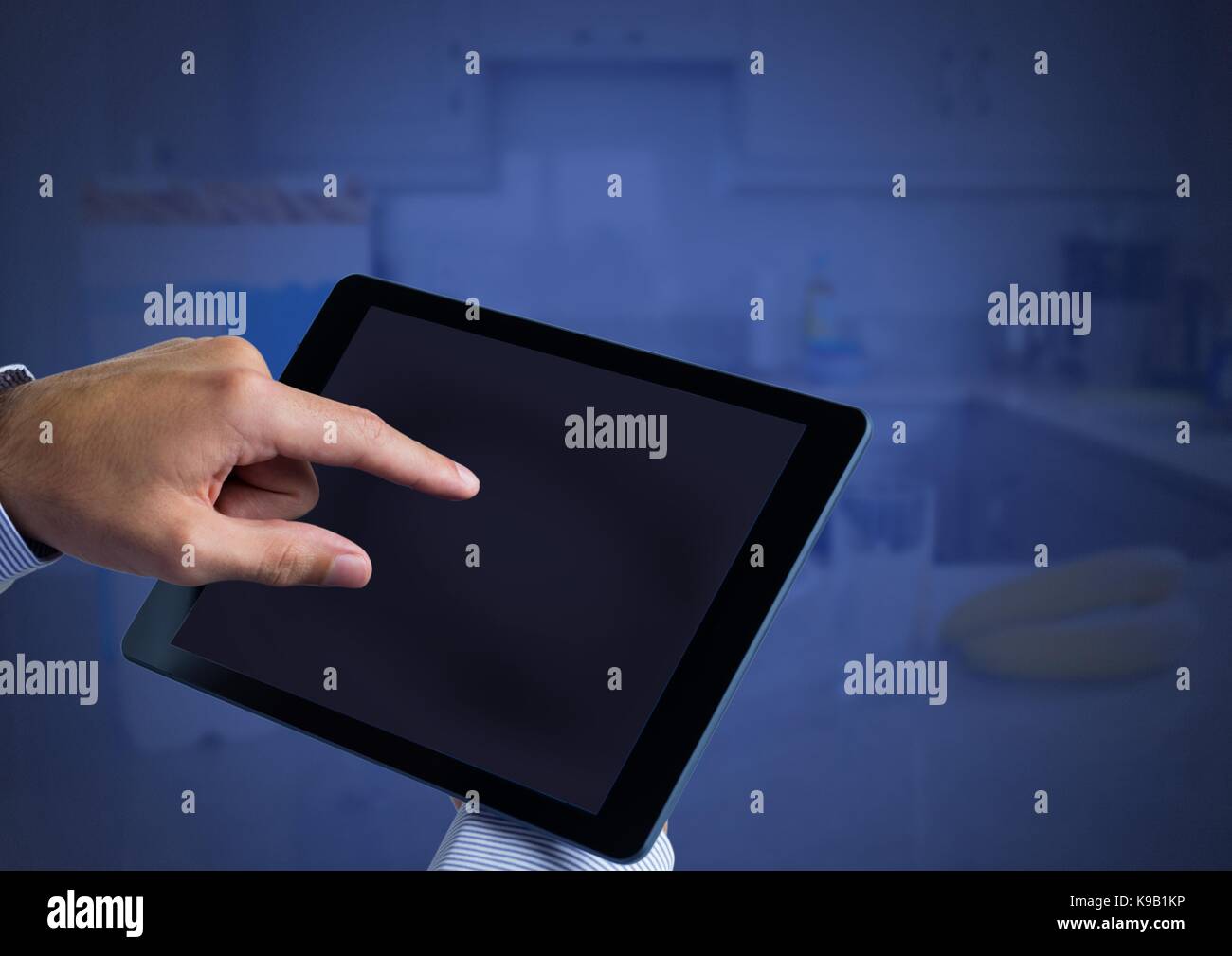 Digital composite of Hand holding tablet at home Stock Photo - Alamy