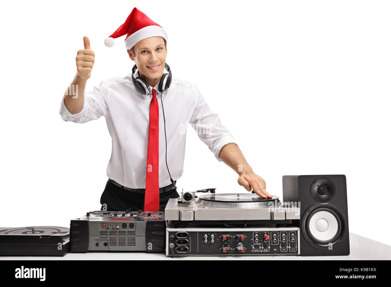 Elegant guy with a christmas hat playing music on a turntable and ...