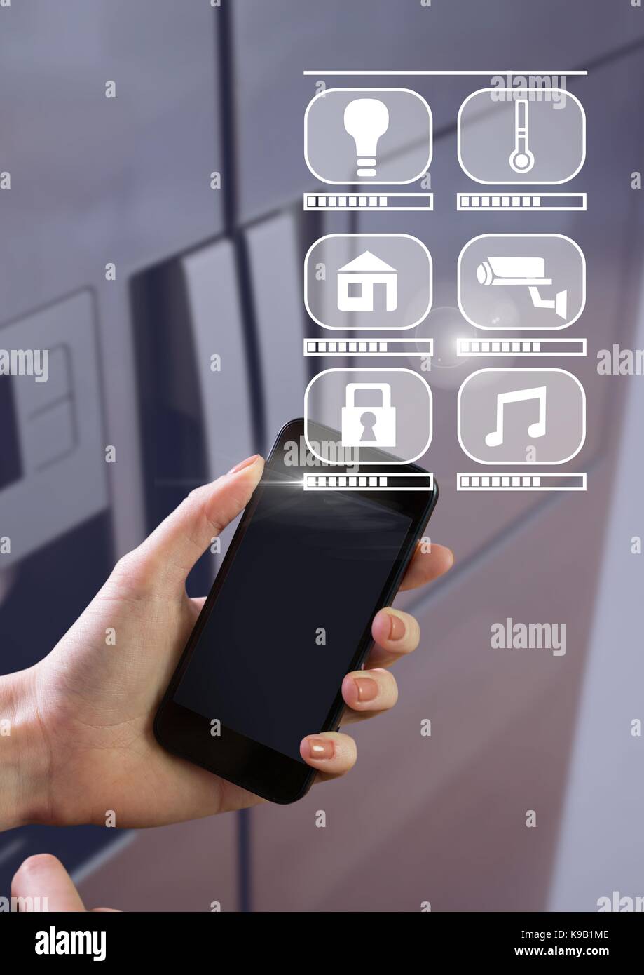 Digital composite of Hand holding phone with smart home interface at ...