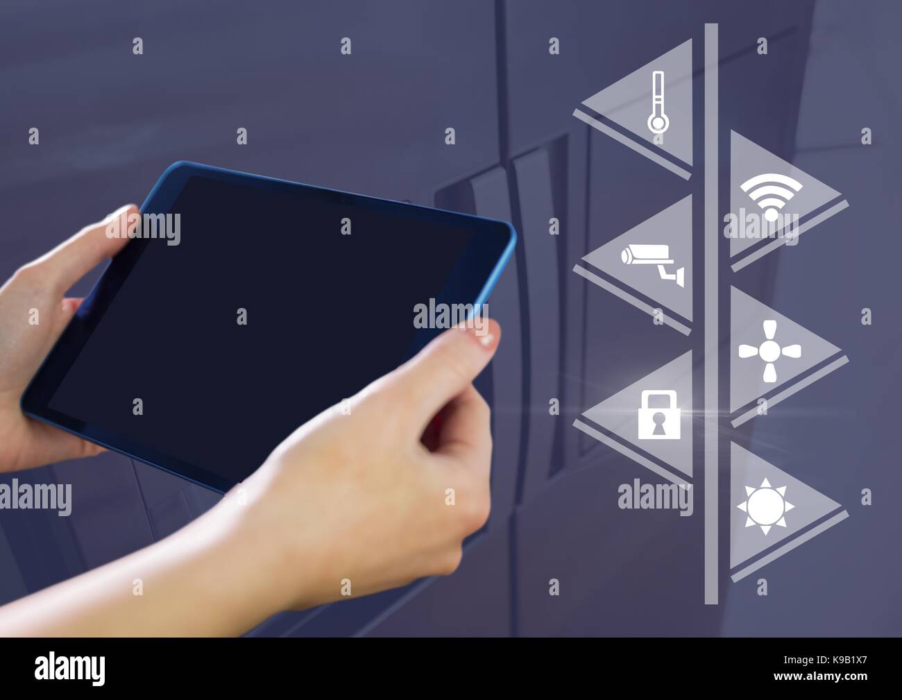 Digital composite of Hand holding tablet with smart home interface at ...