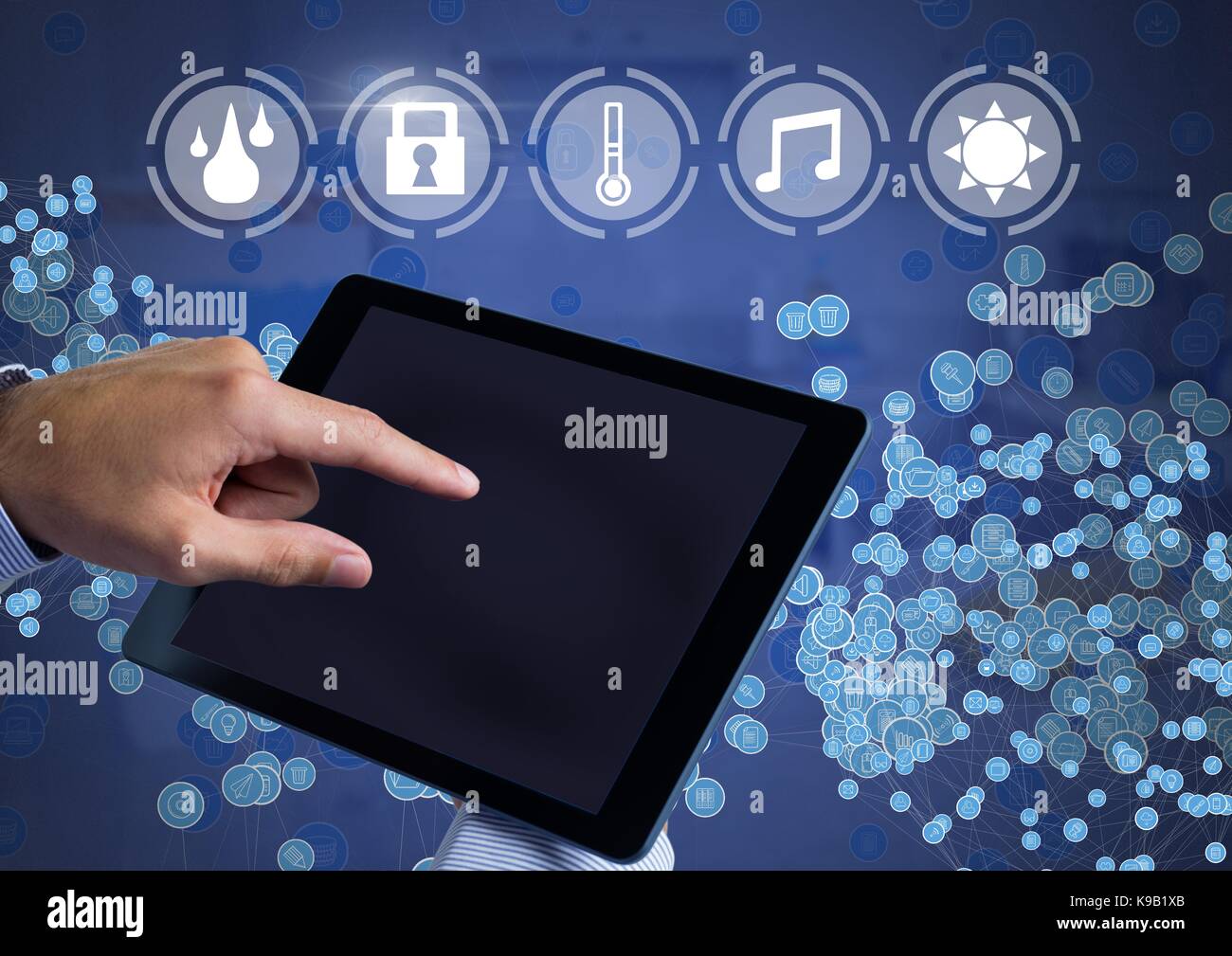 Digital composite of Hand holding tablet with smart home interface and ...