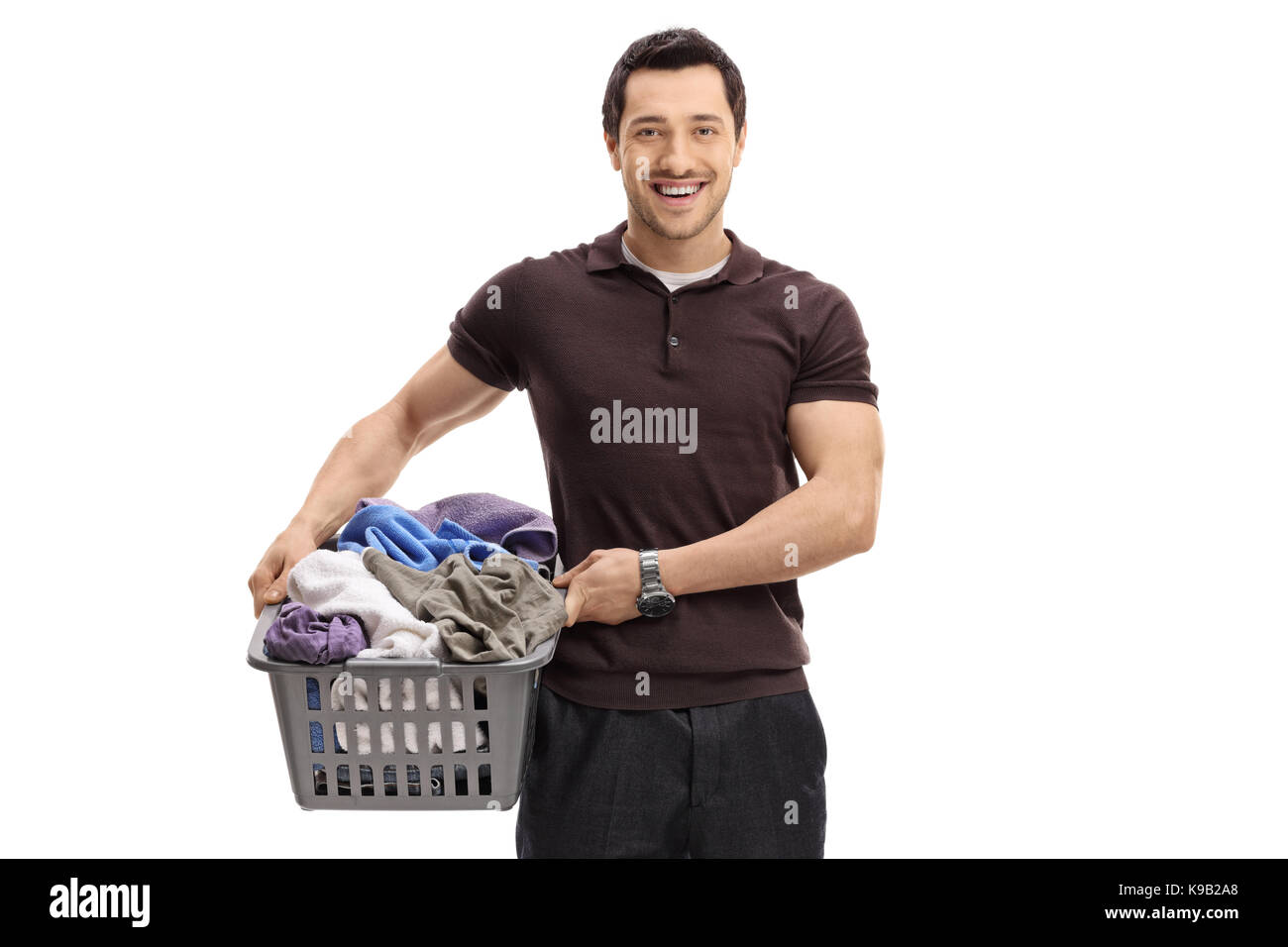 Guy with a laundry basket full of clothes isolated on white background ...