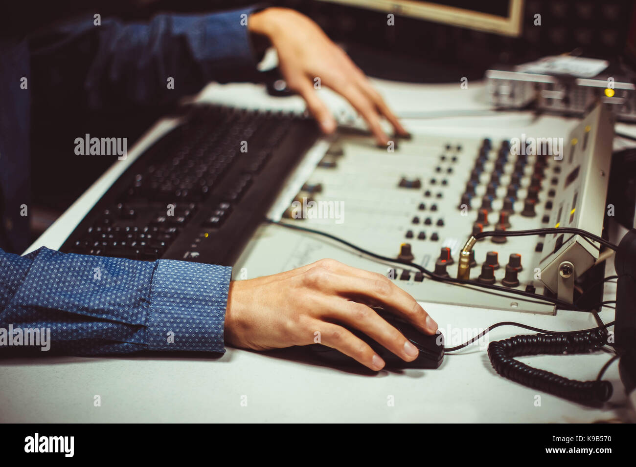 Professional audio mixing console with faders and adjusting knobs ...