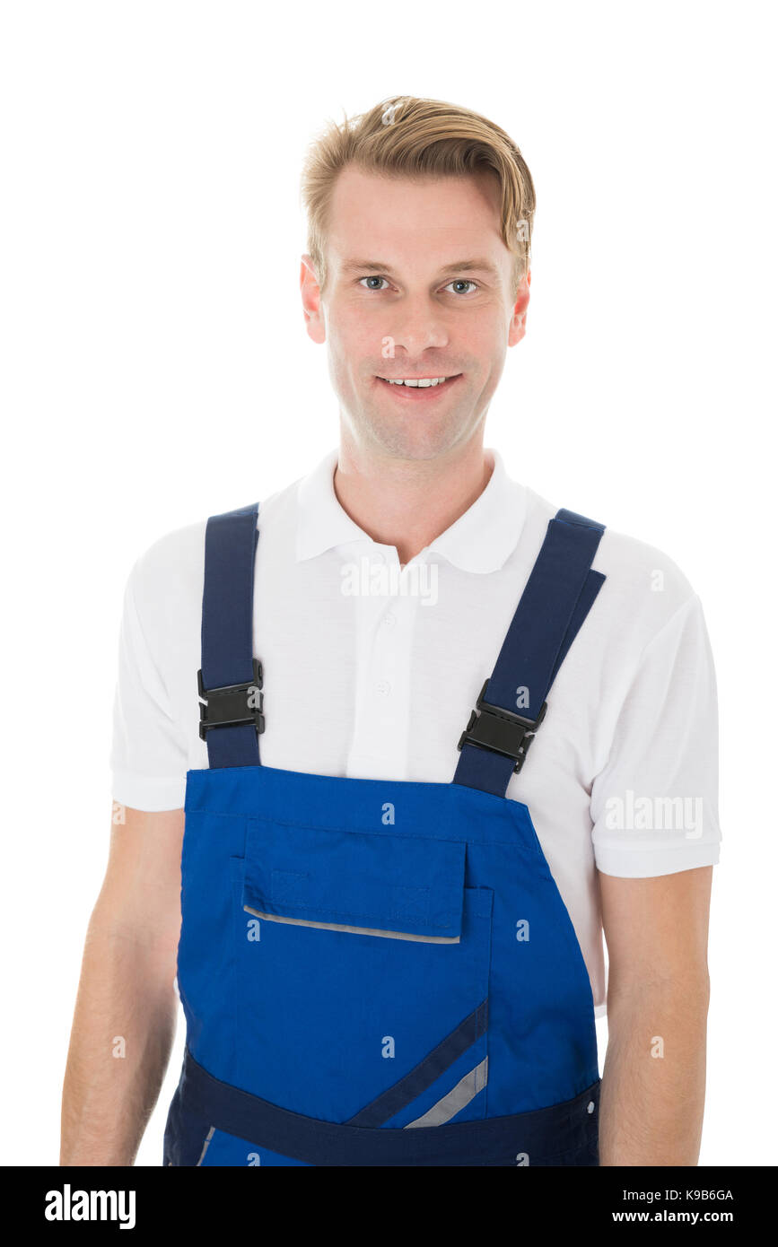 Portrait of smiling mid adult male janitor standing against white ...