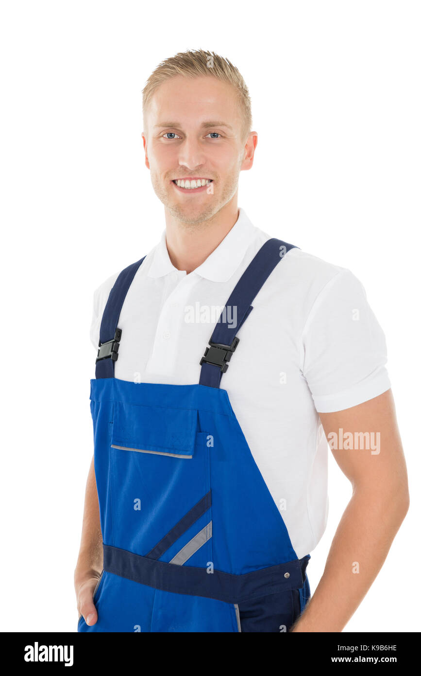 Portrait of smiling mid adult male janitor standing against white ...