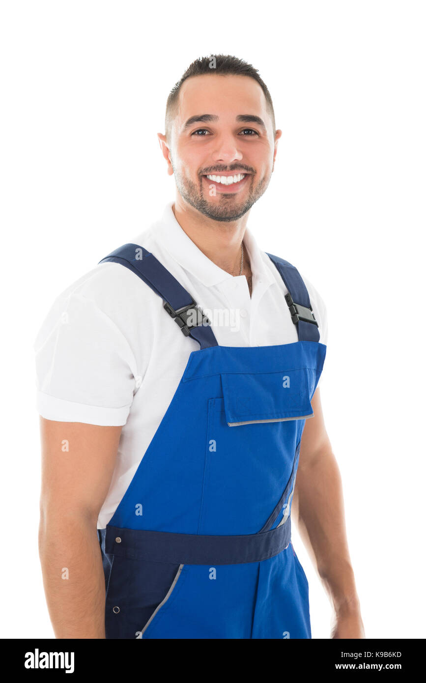 Portrait of happy young janitor standing against white background Stock ...