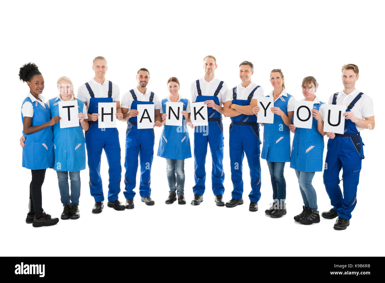 Full length portrait of confident janitors holding Thank You sign ...