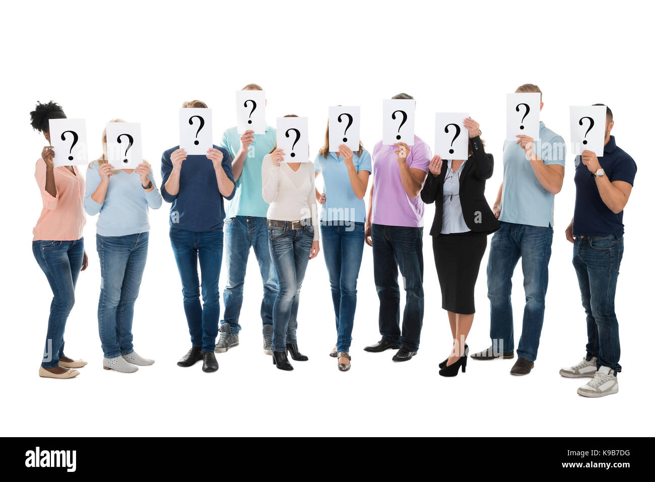 Full length of creative business team hiding faces with question mark ...