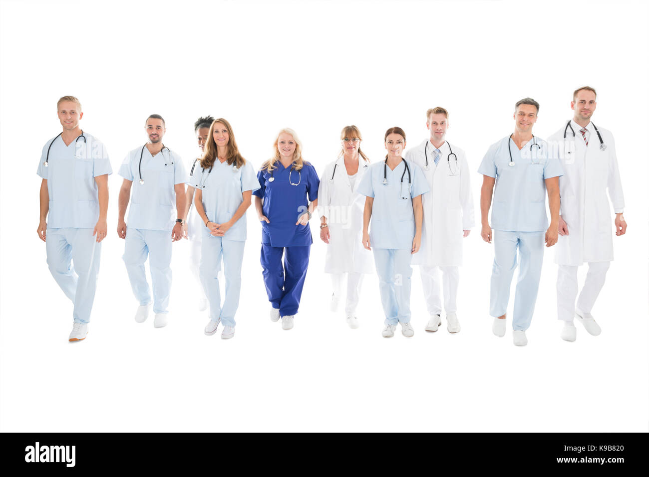 Full length portrait of confident multiethnic medical team walking in ...