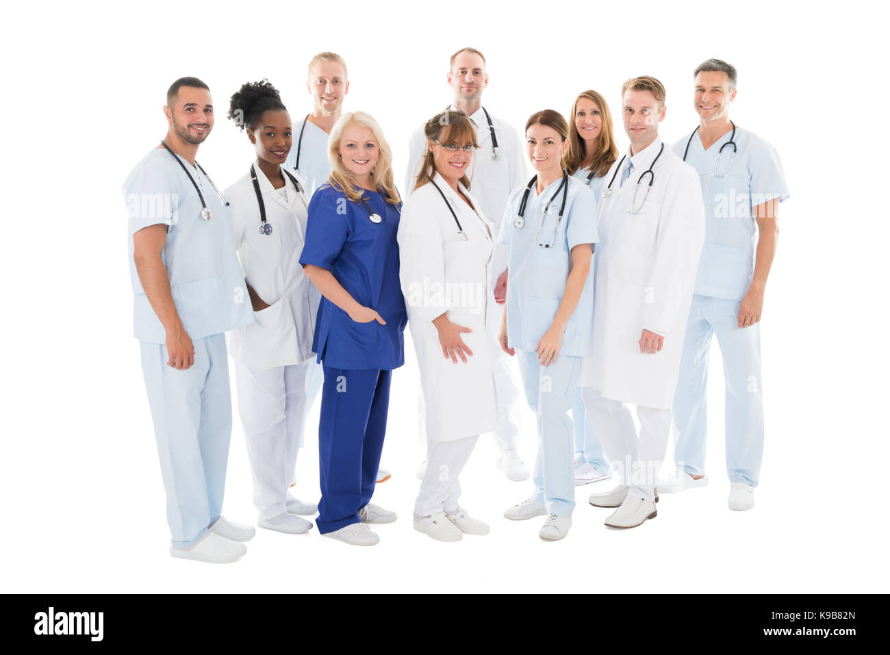 Full length portrait of confident multiethnic medical team standing in ...