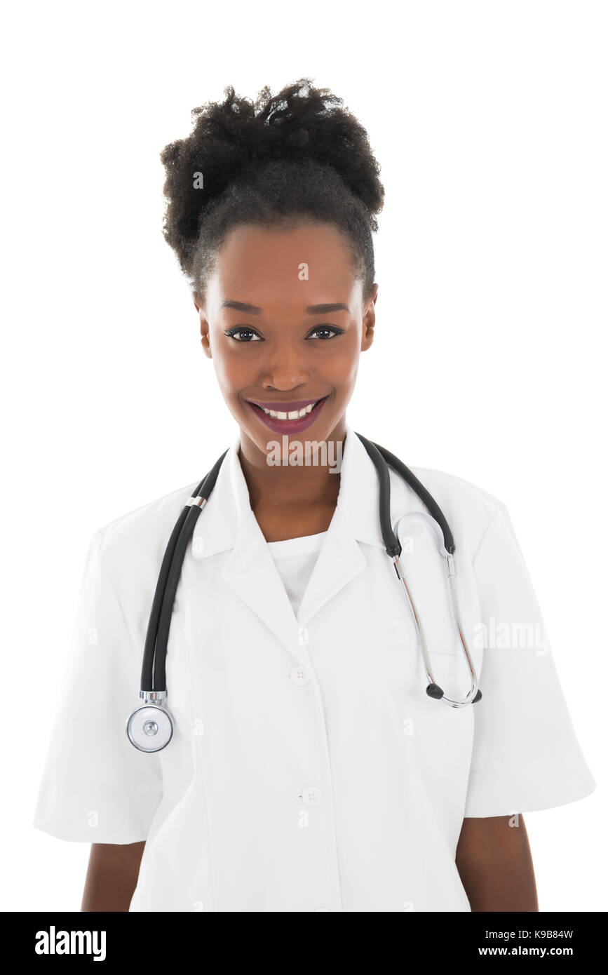 Portrait of happy female doctor standing against white background Stock ...
