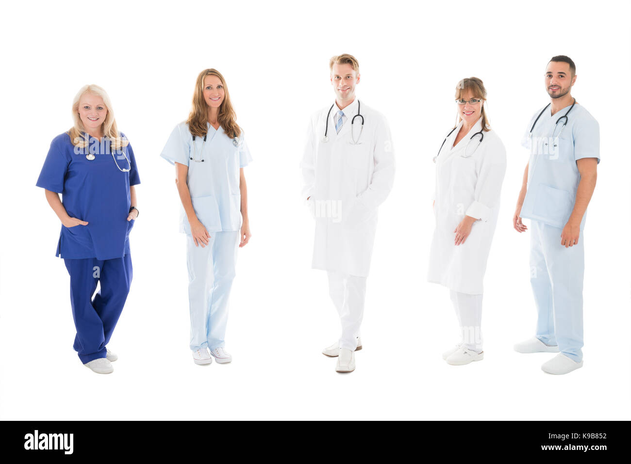 Full length portrait of confident medical team standing in row against ...