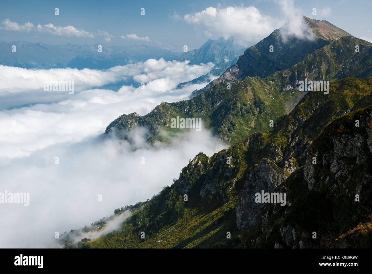 Beautiful clouds and fog among mountain landscape Stock Photo - Alamy