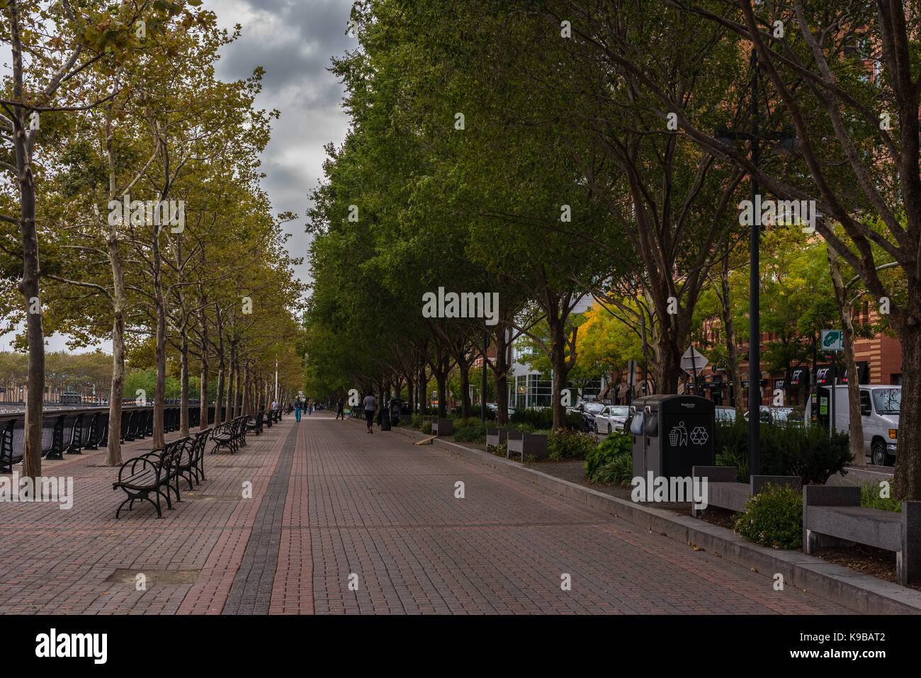 Hoboken, NJ USA -- September 19, 2017 A brick promenade between the ...
