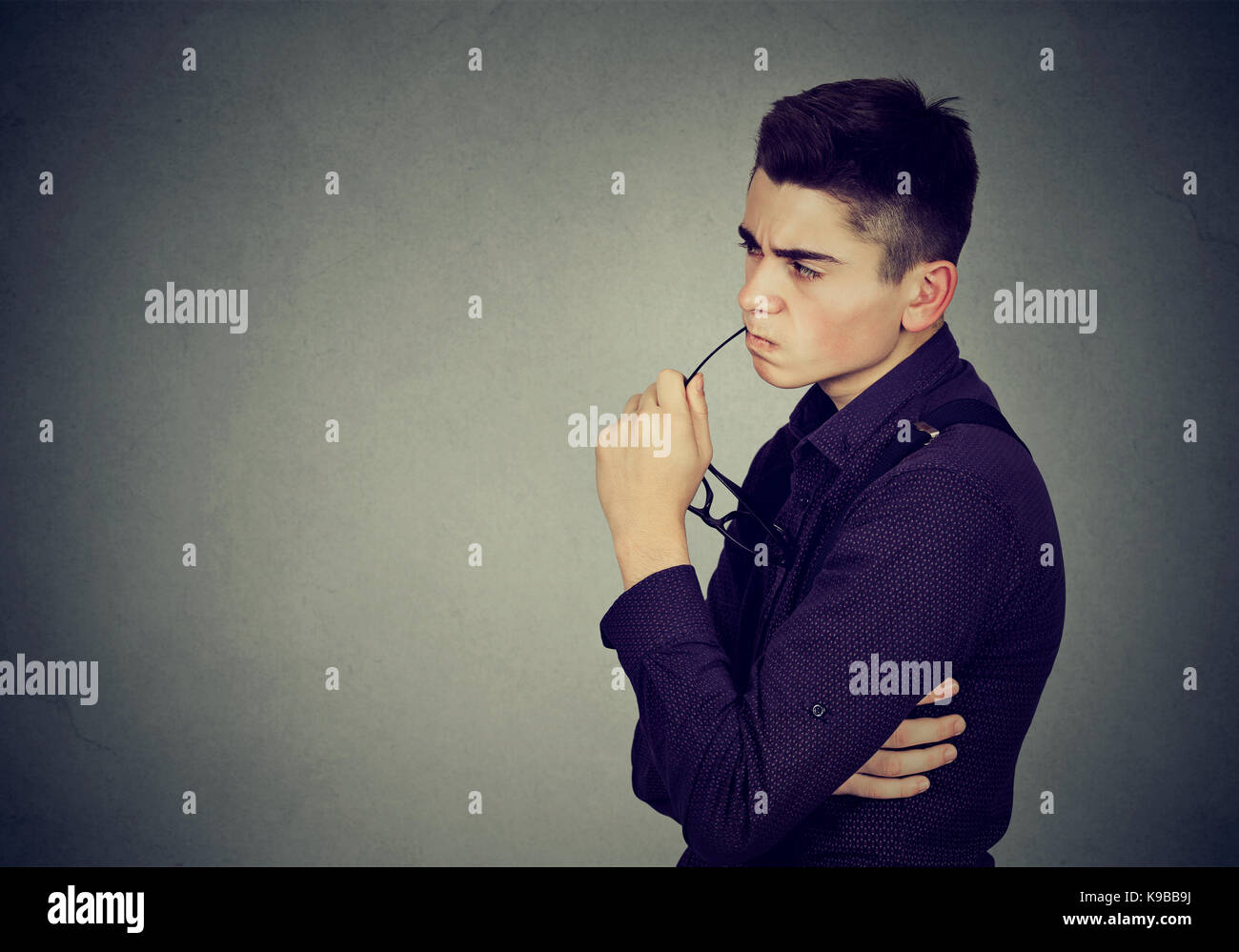 Suspicious doubtful young man Stock Photo - Alamy