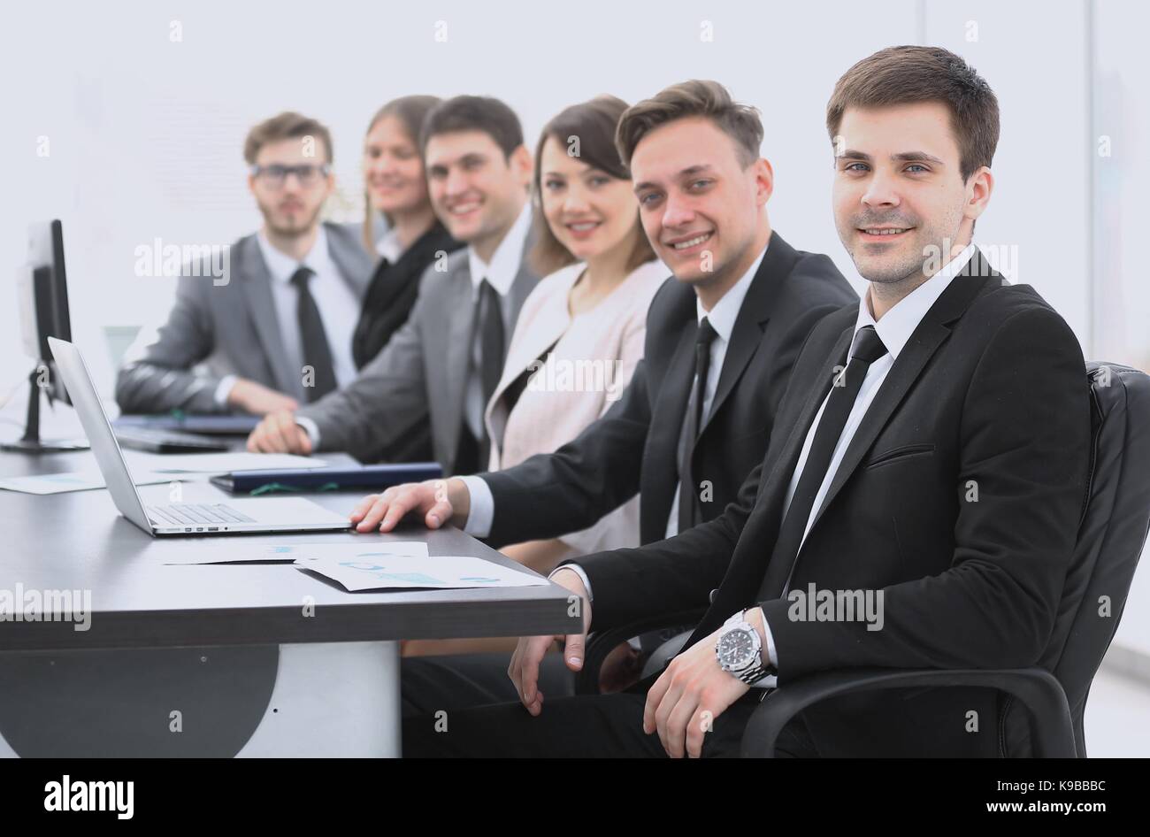 project Manager and professional business team sitting at Desk Stock ...